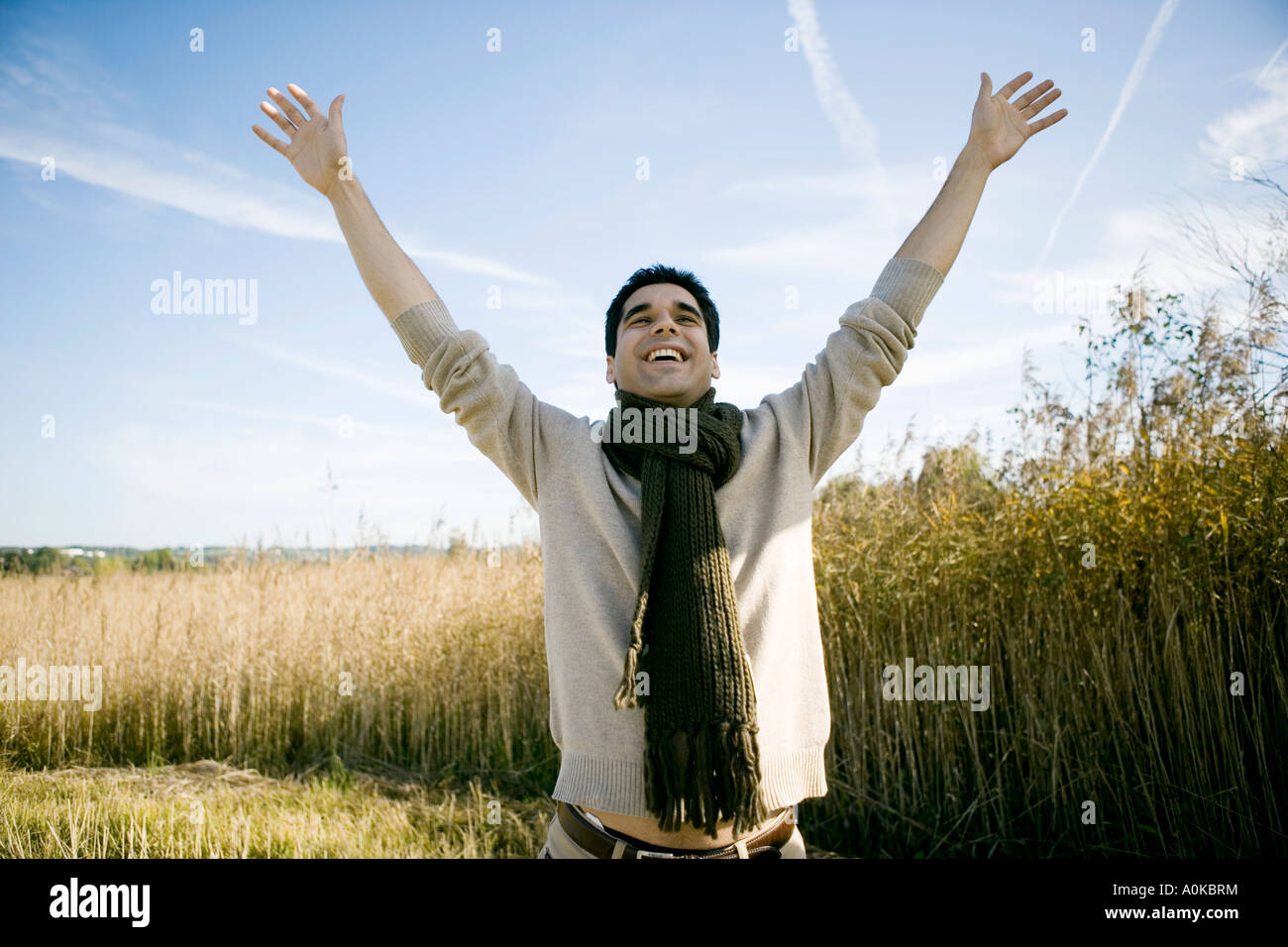 young man raising his arms in autumnal field Stock Photo - Alamy