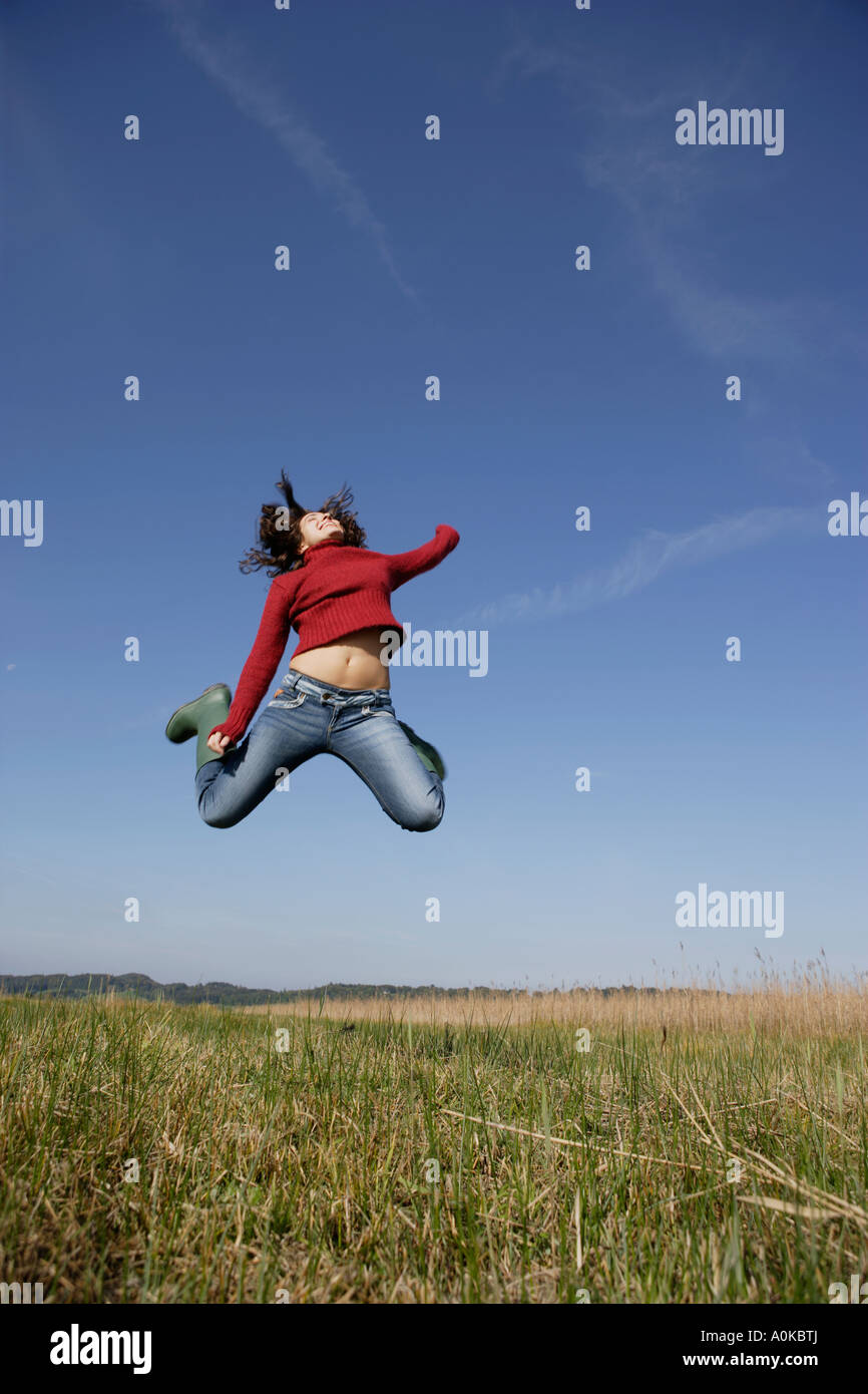 Woman happy blue sky red jumper hi-res stock photography and images - Alamy