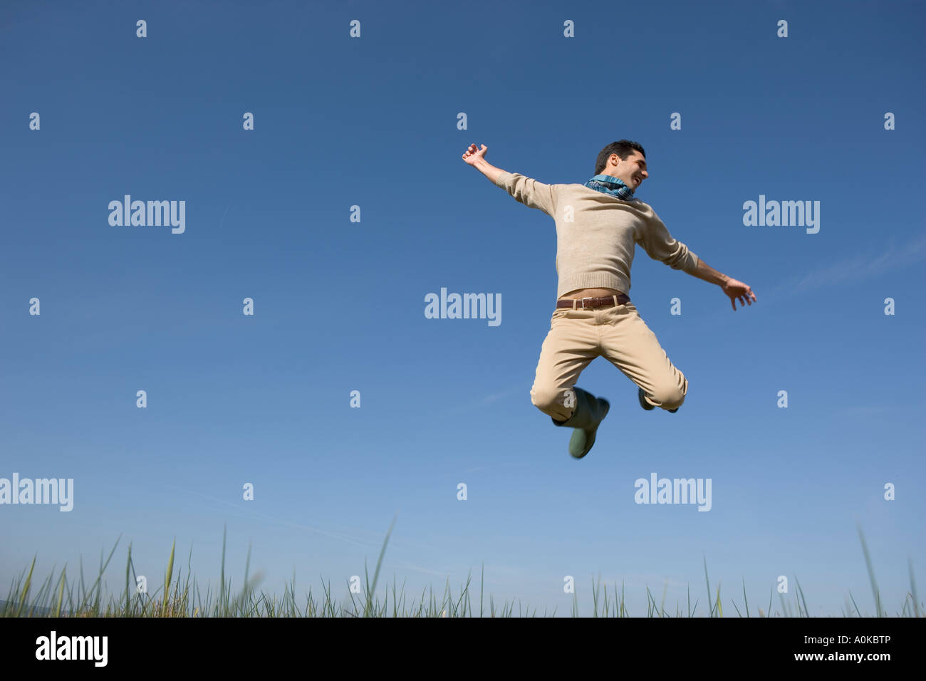 joyous young man doing a high jump Stock Photo - Alamy