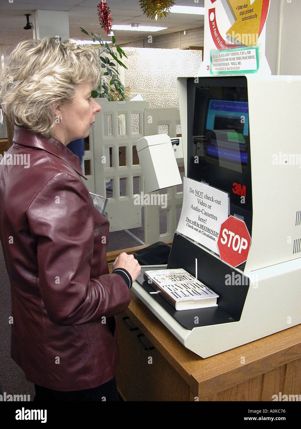 Adult Female Uses Automated Check Out System in Library Stock Photo - Alamy