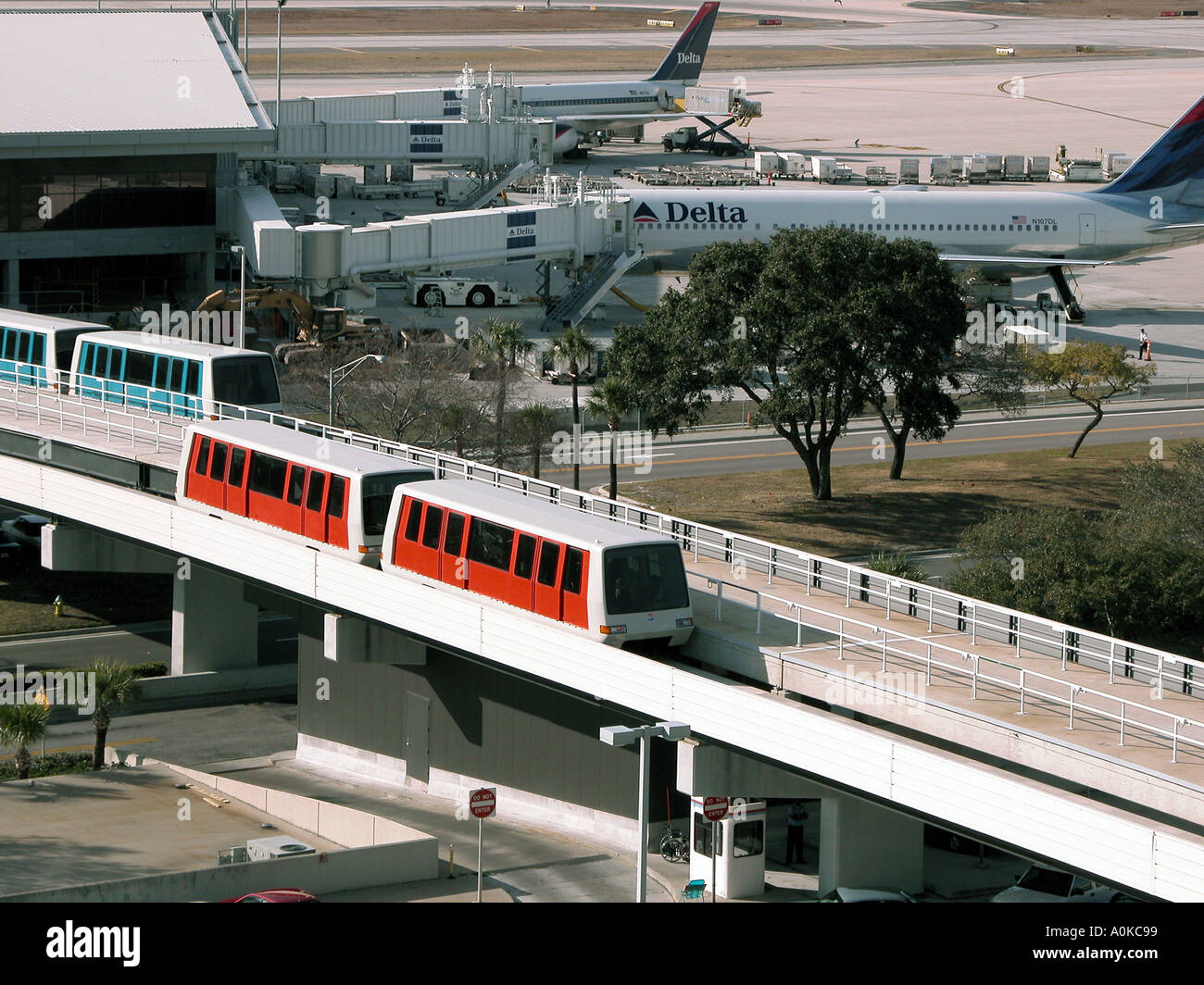 Tram Shuttles People from Terminal To Airplane Stock Photo - Alamy
