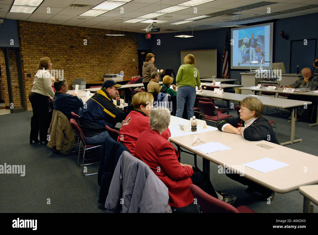 A group of professional workers attend a power point presentation at a ...