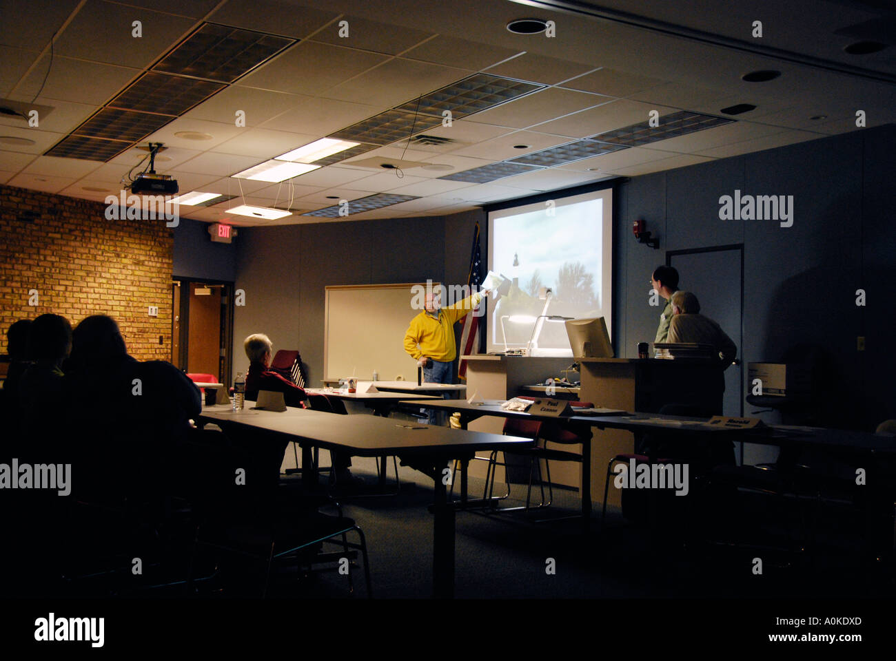 A group of professional workers attend a power point presentation at a ...