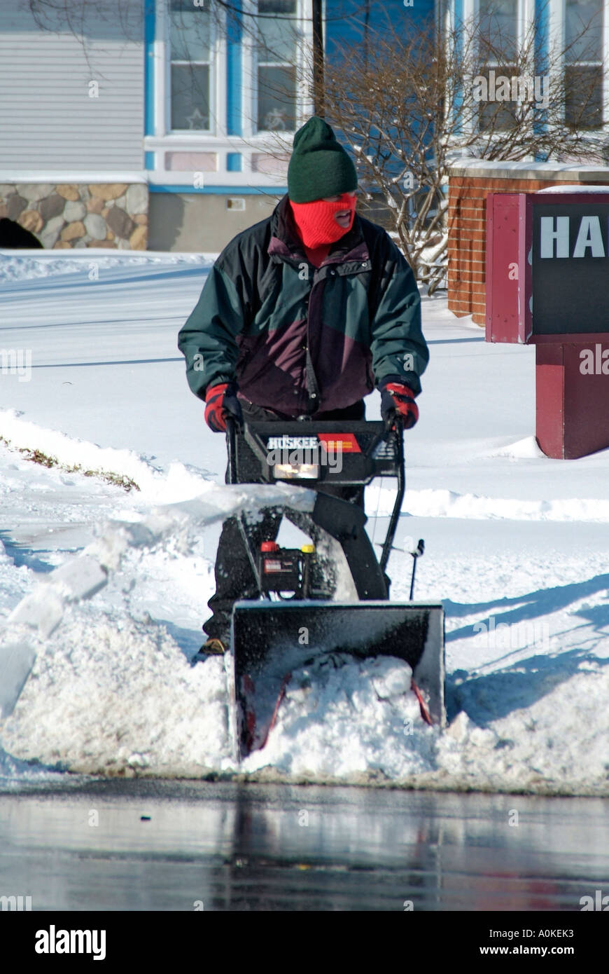 Adult Male Clears Snow From Property With Snow Blower Stock Photo - Alamy