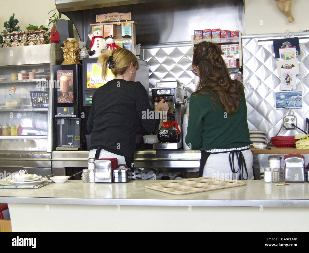 Waitress in a small restaurant wait on people who order food Stock ...