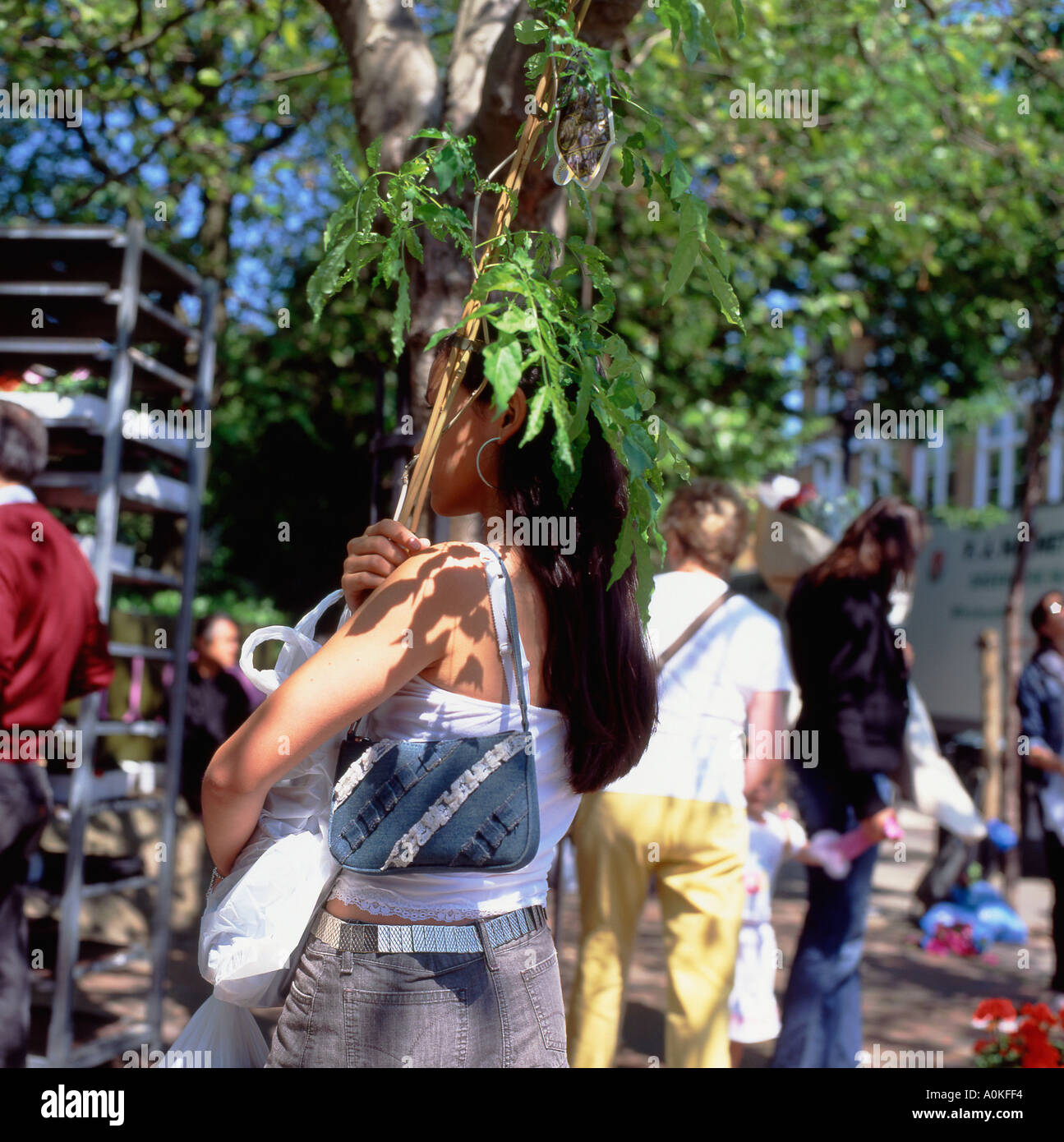 Woman carrying plant at Columbia Road Market in Hackney Tower Hamlets ...