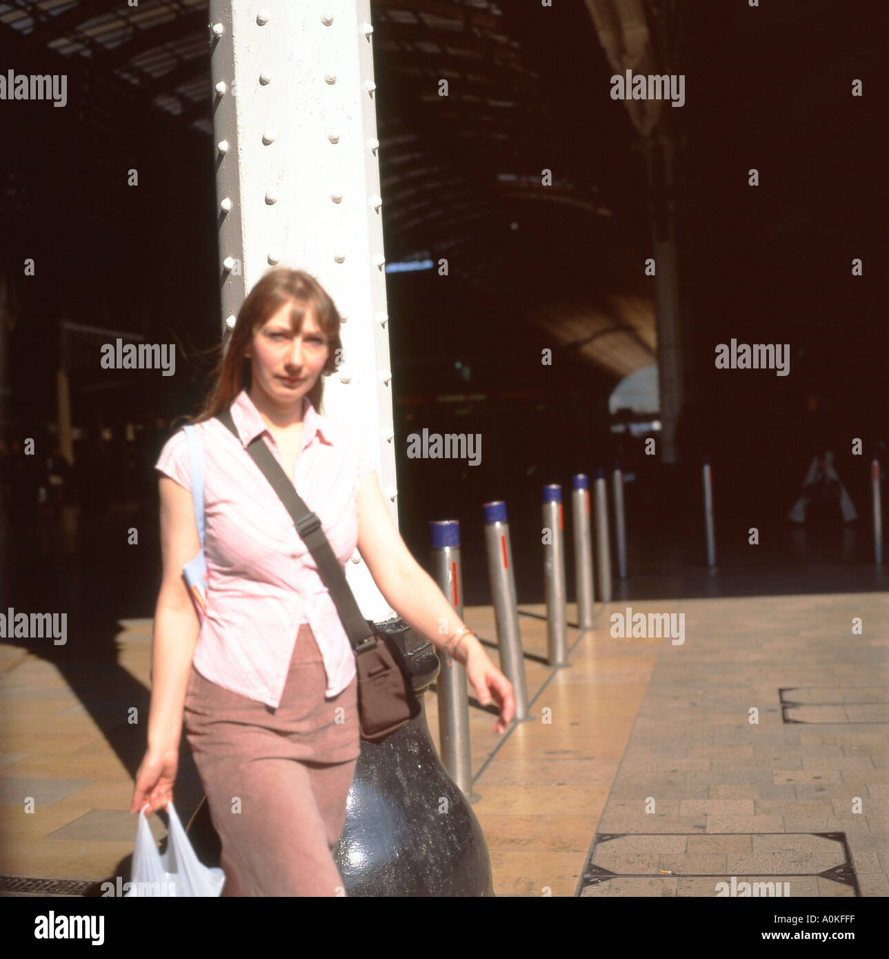 A young female commuter leaving Paddington Station on her way to work ...
