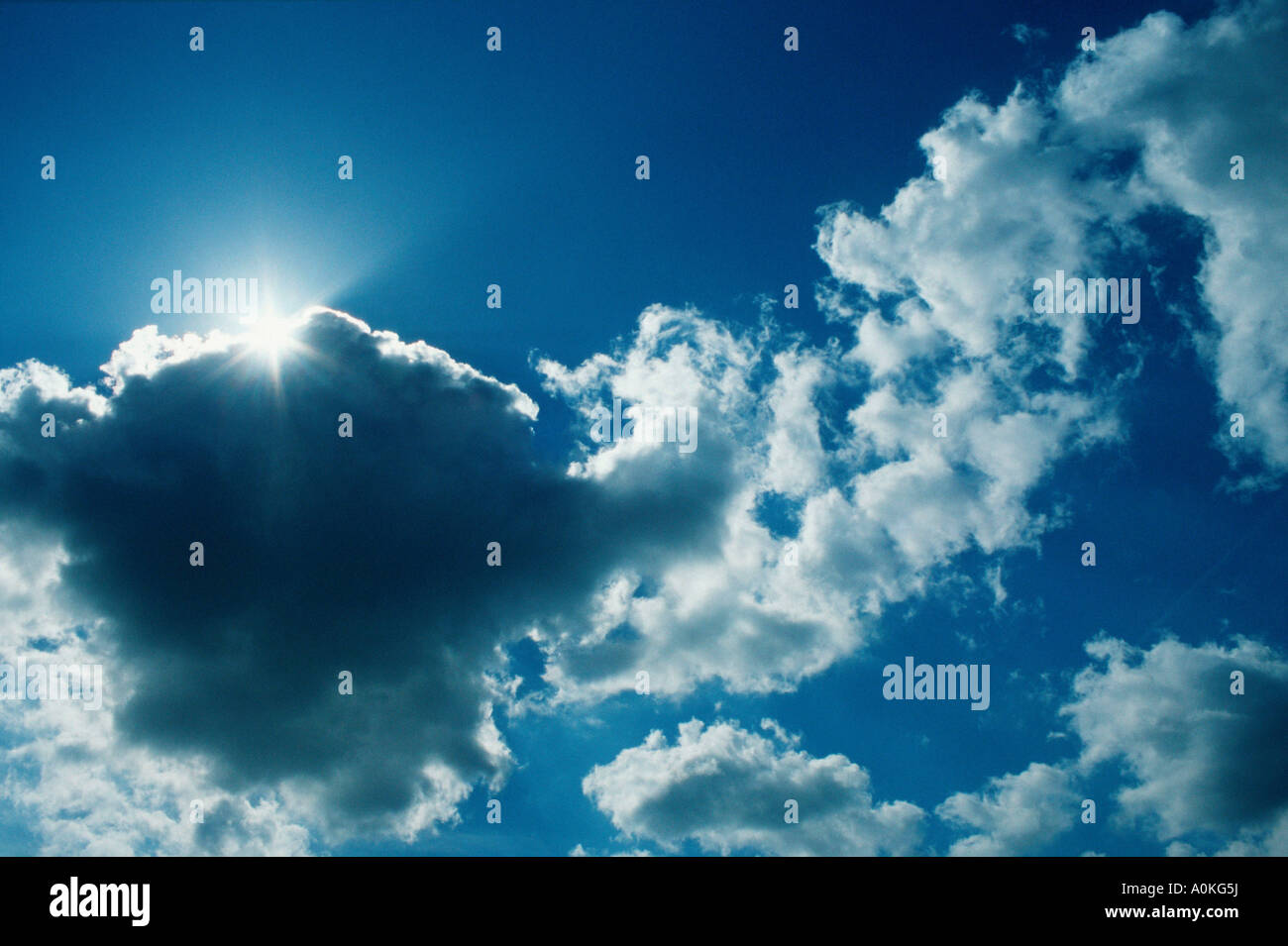 Sun behind clouds Stock Photo - Alamy