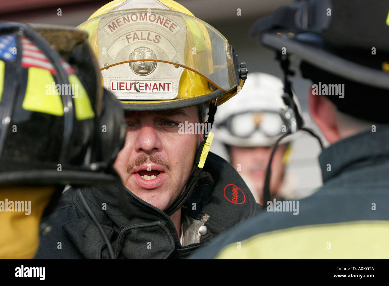 A fire fighter is giving orders to fire fighters at scene of a mass ...
