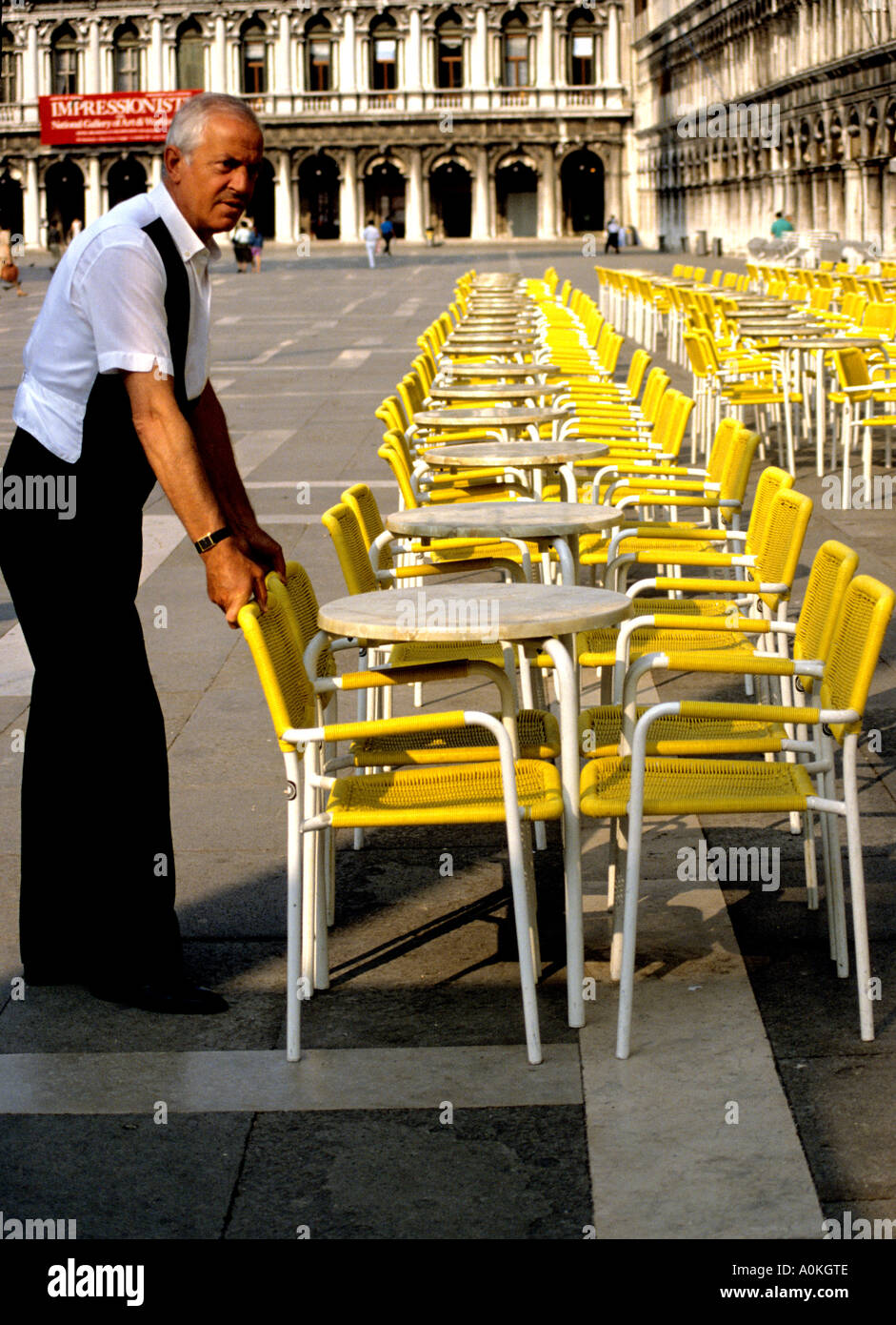 Italian waiter Setting up cafe in St Marks Square,Piazzo San Marco ...