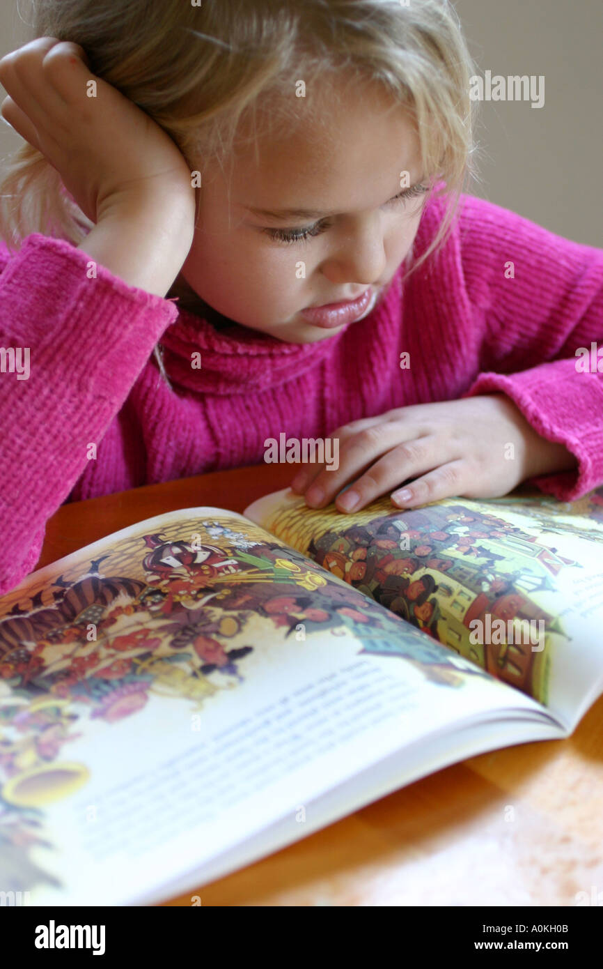 girl frustrated trying to read storybook Stock Photo - Alamy