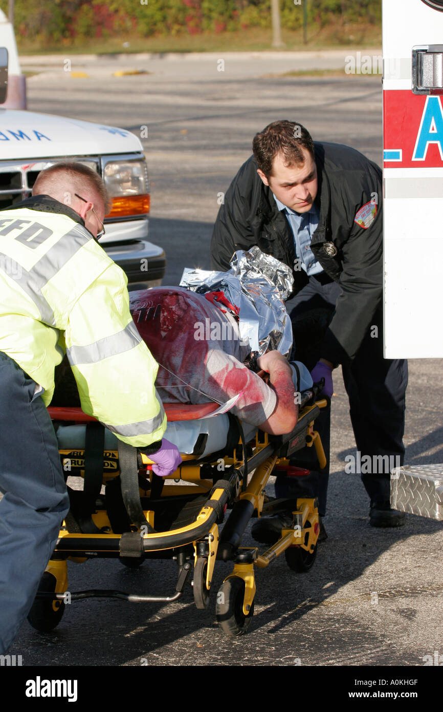 EMTs are loading a victim onto a stretcher to go into an Ambulance ...