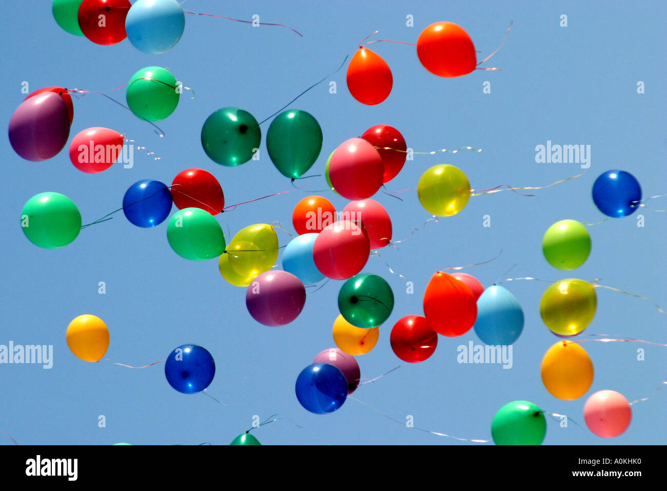 Festive coloured balloons in a blue sky Stock Photo - Alamy