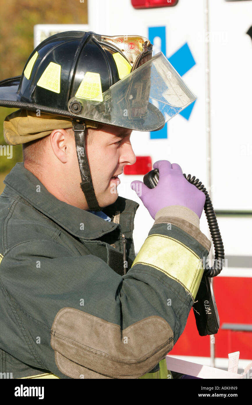 A fire fighter is listening and talking on a radio Stock Photo - Alamy