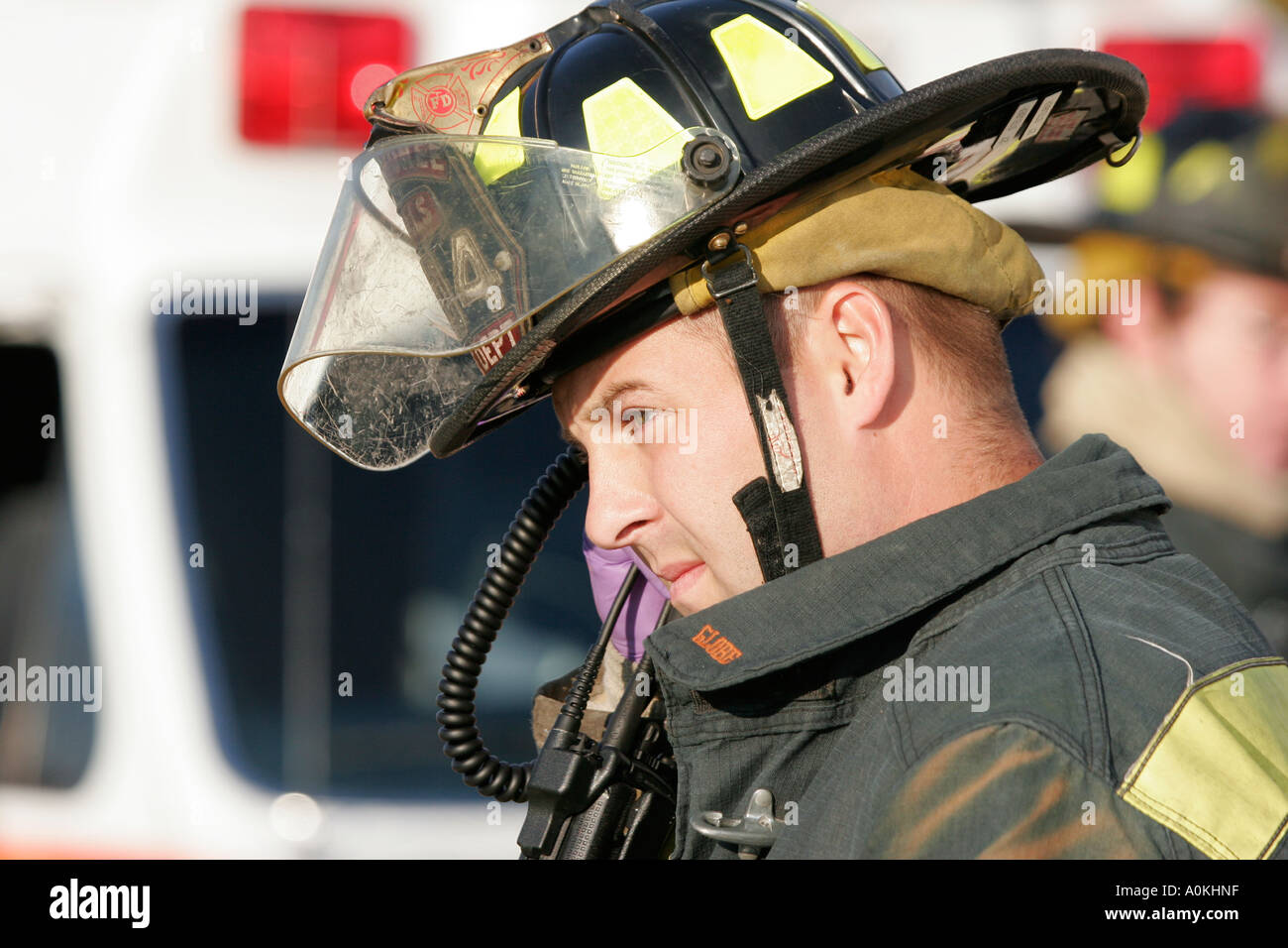 A fire fighter is listening and talking on a radio Stock Photo - Alamy