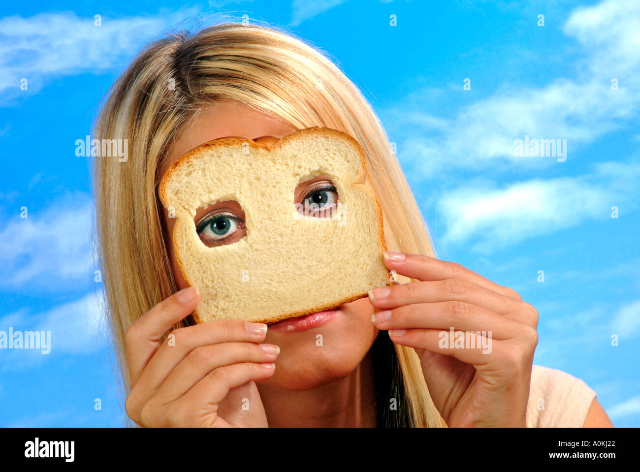 Girl hiding behind bread Stock Photo - Alamy
