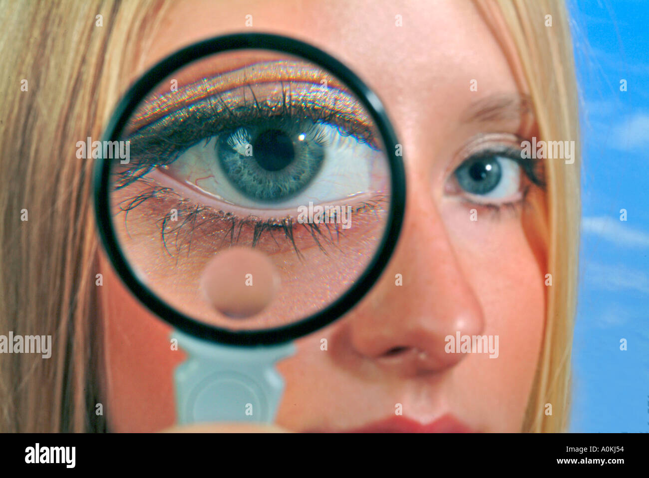 eye looking through magnifying glass Stock Photo - Alamy