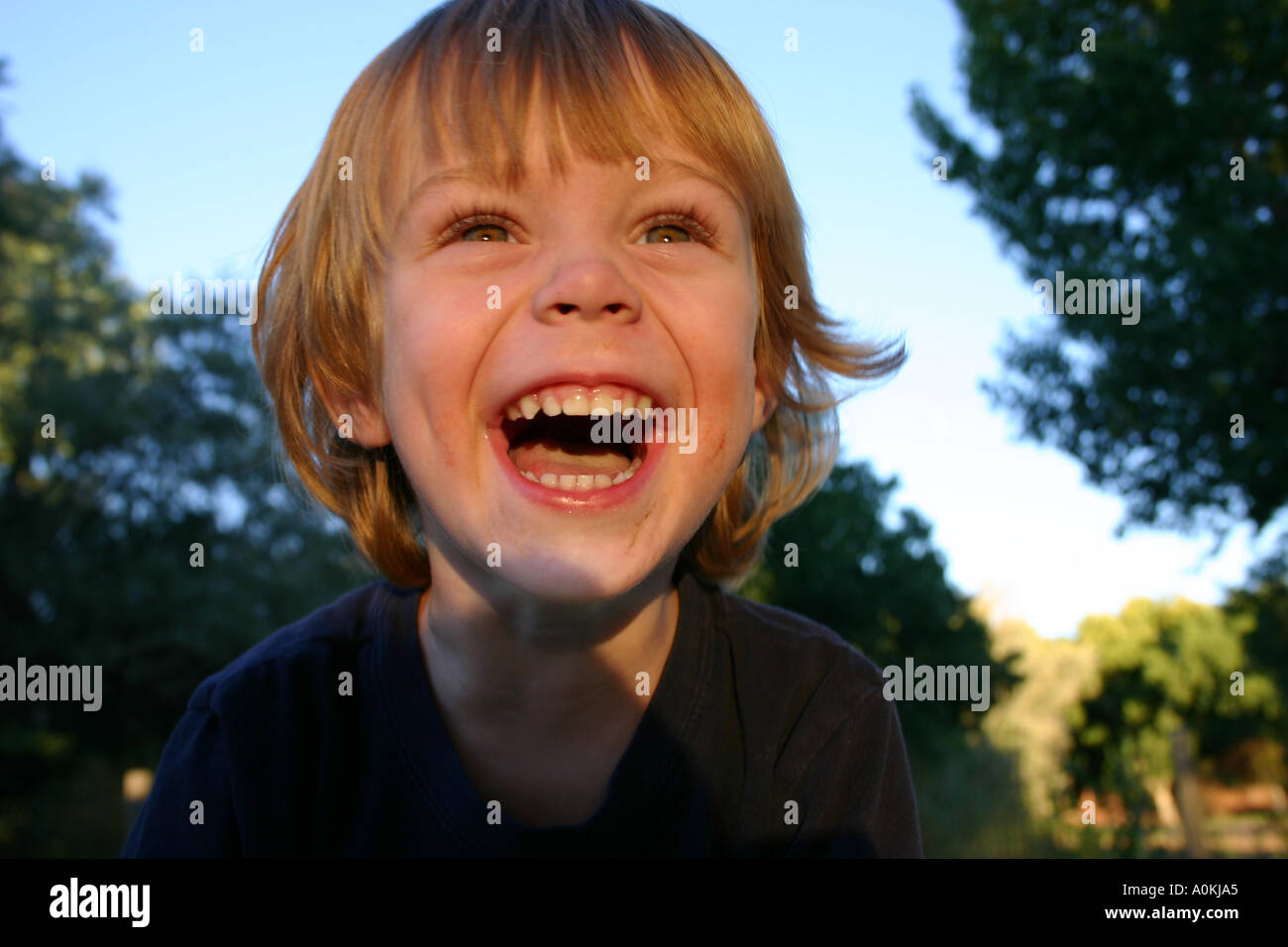 boy laughing sunset Stock Photo - Alamy