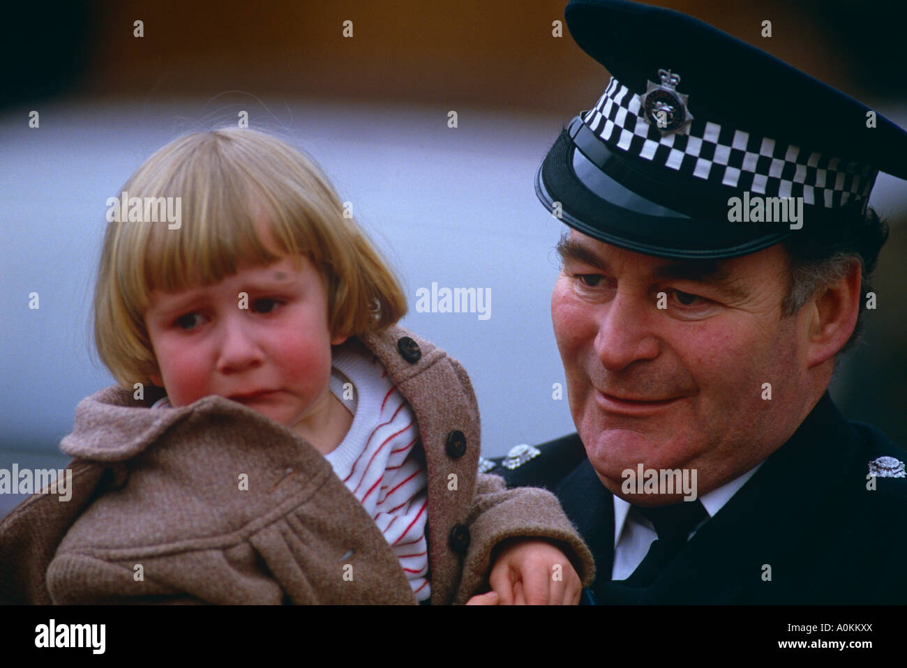 A British police man comforts a crying lost child, at an event in ...