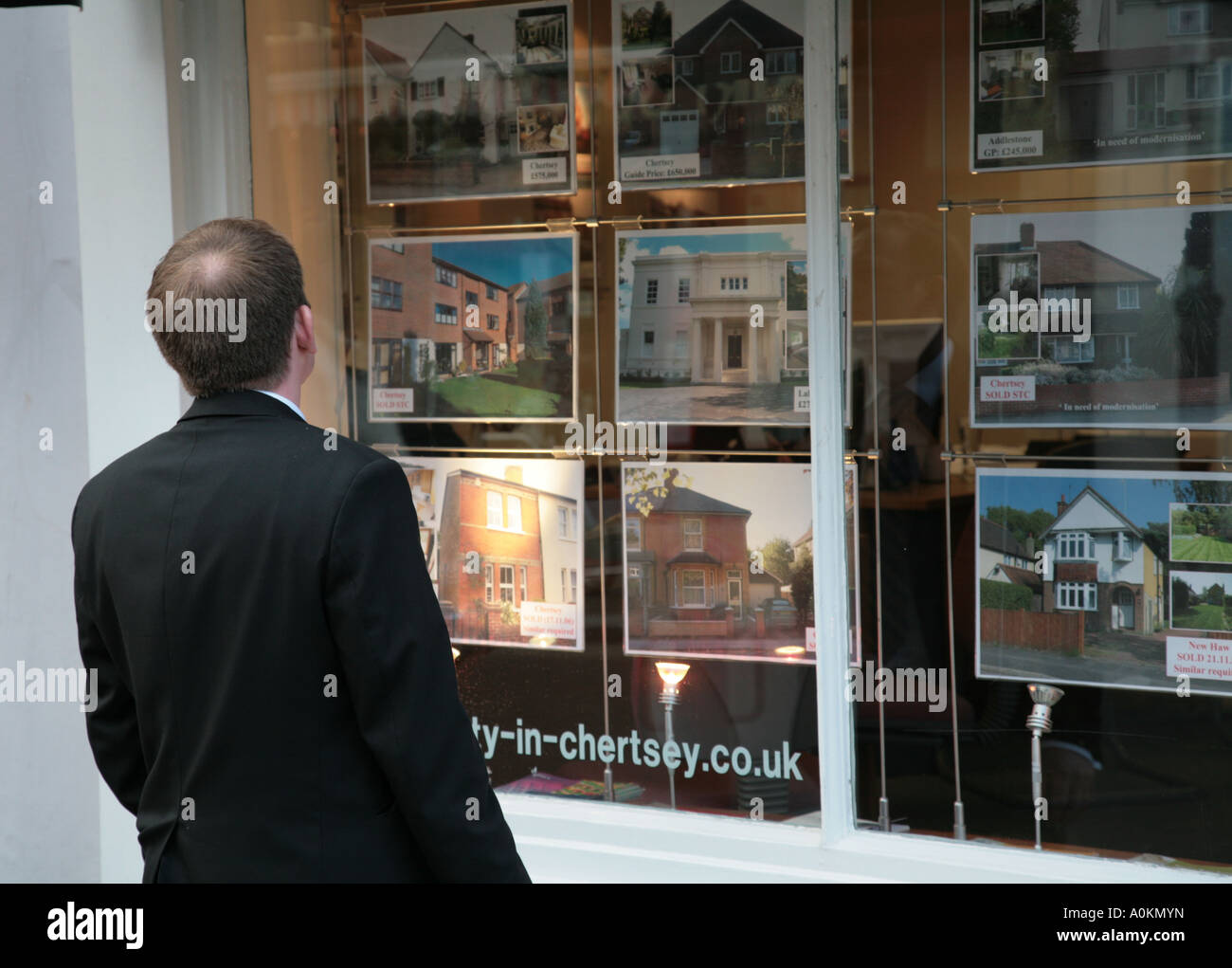 man browsing estate agent window Stock Photo - Alamy