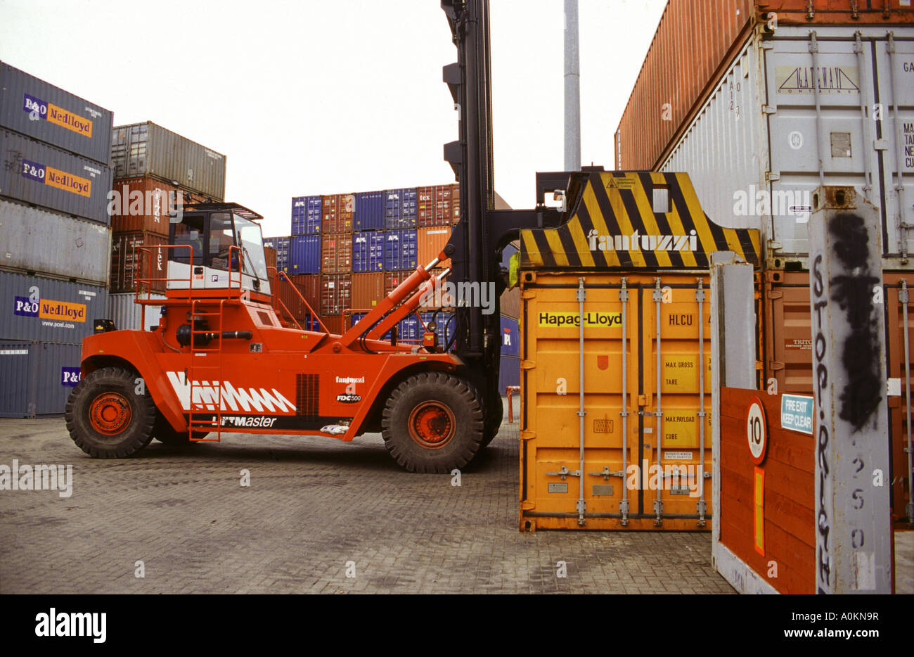 High lift fork truck with spreader Stock Photo - Alamy
