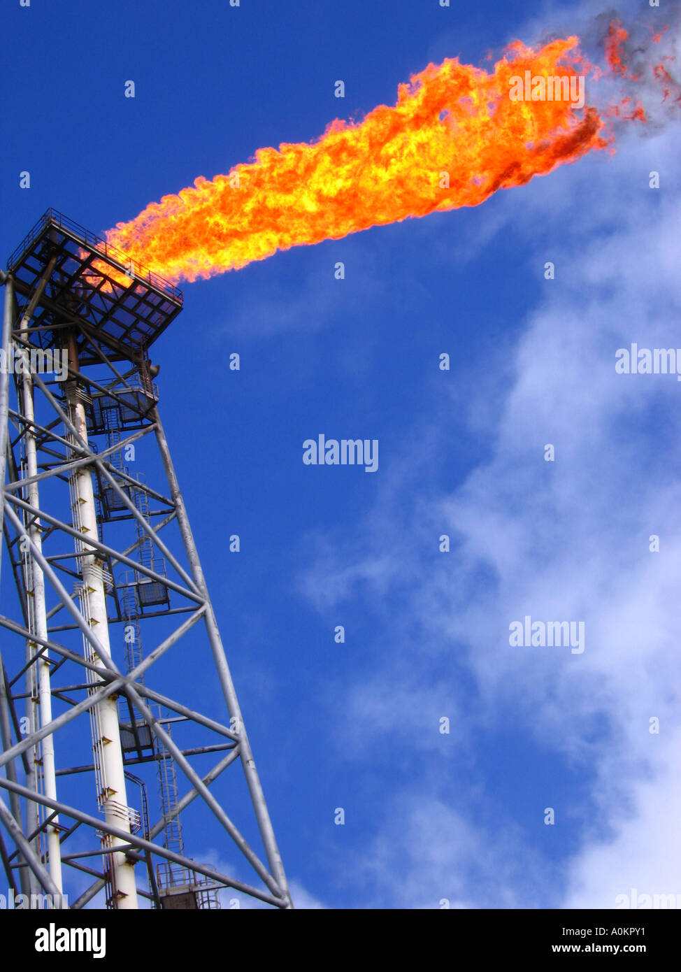 Full frame view of a lit offshore gas flare and column Stock Photo - Alamy