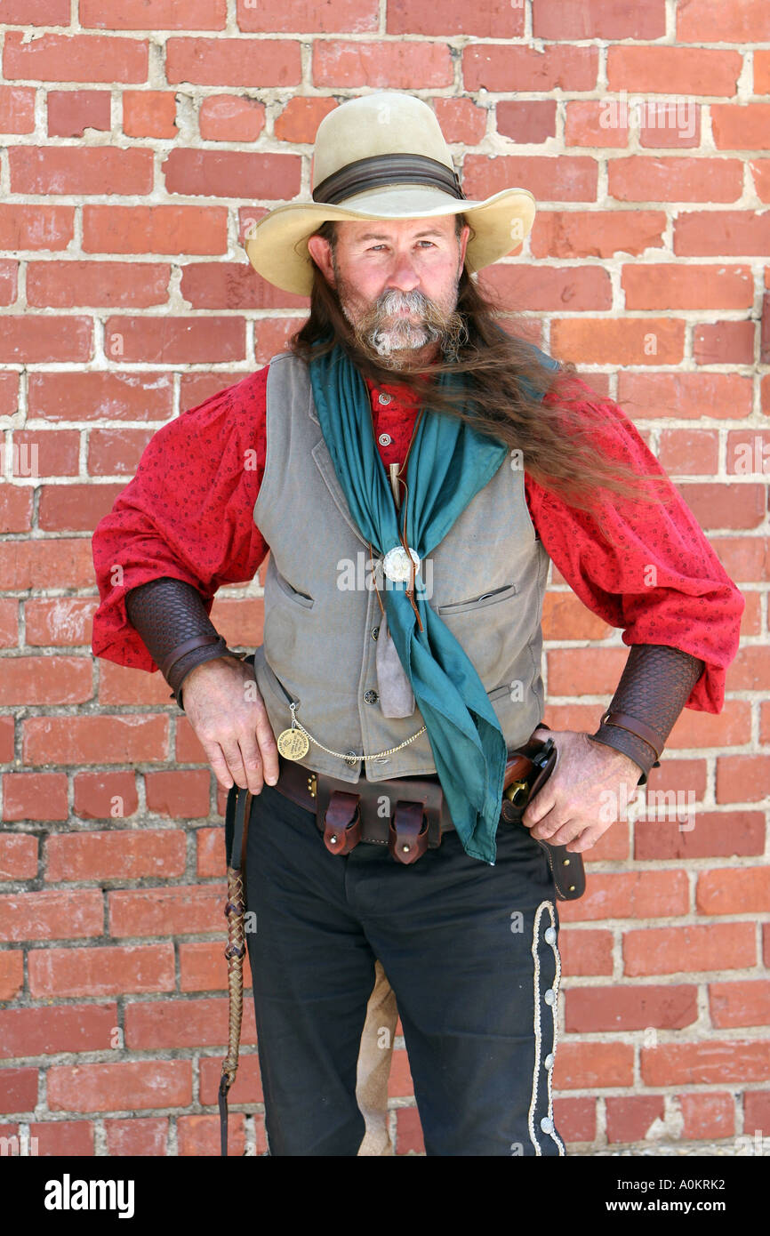 Texas gunfighter against a brick wall Stock Photo - Alamy