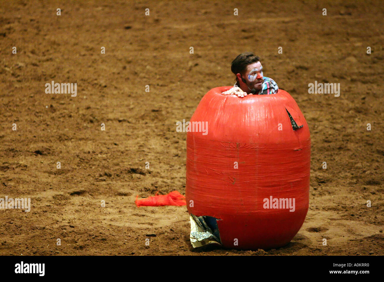A rodeo clown hides inside a barrel Stock Photo - Alamy