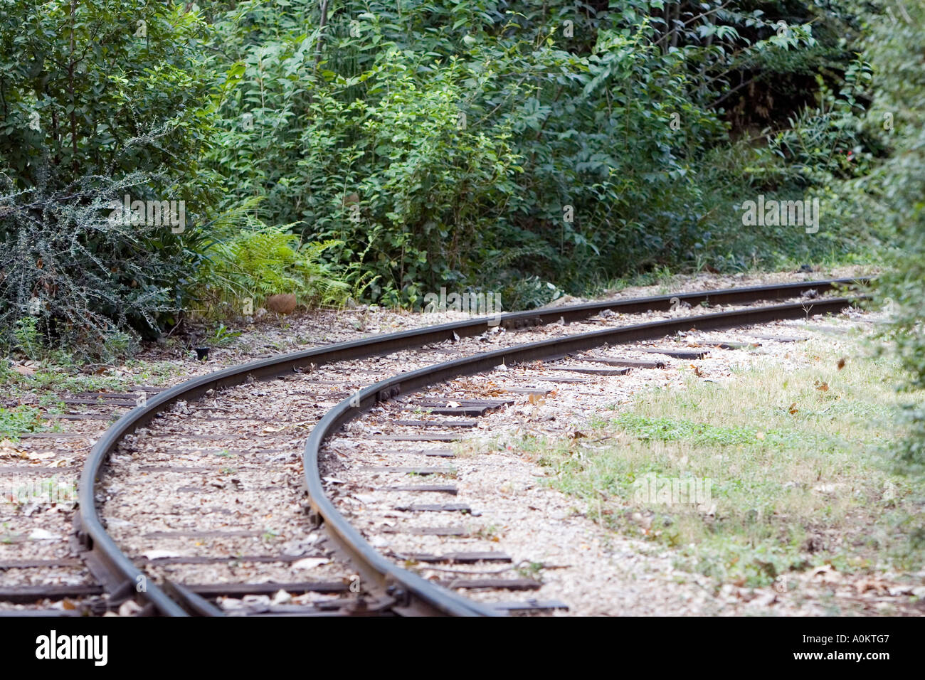 Train tracks bending around a corner Stock Photo - Alamy