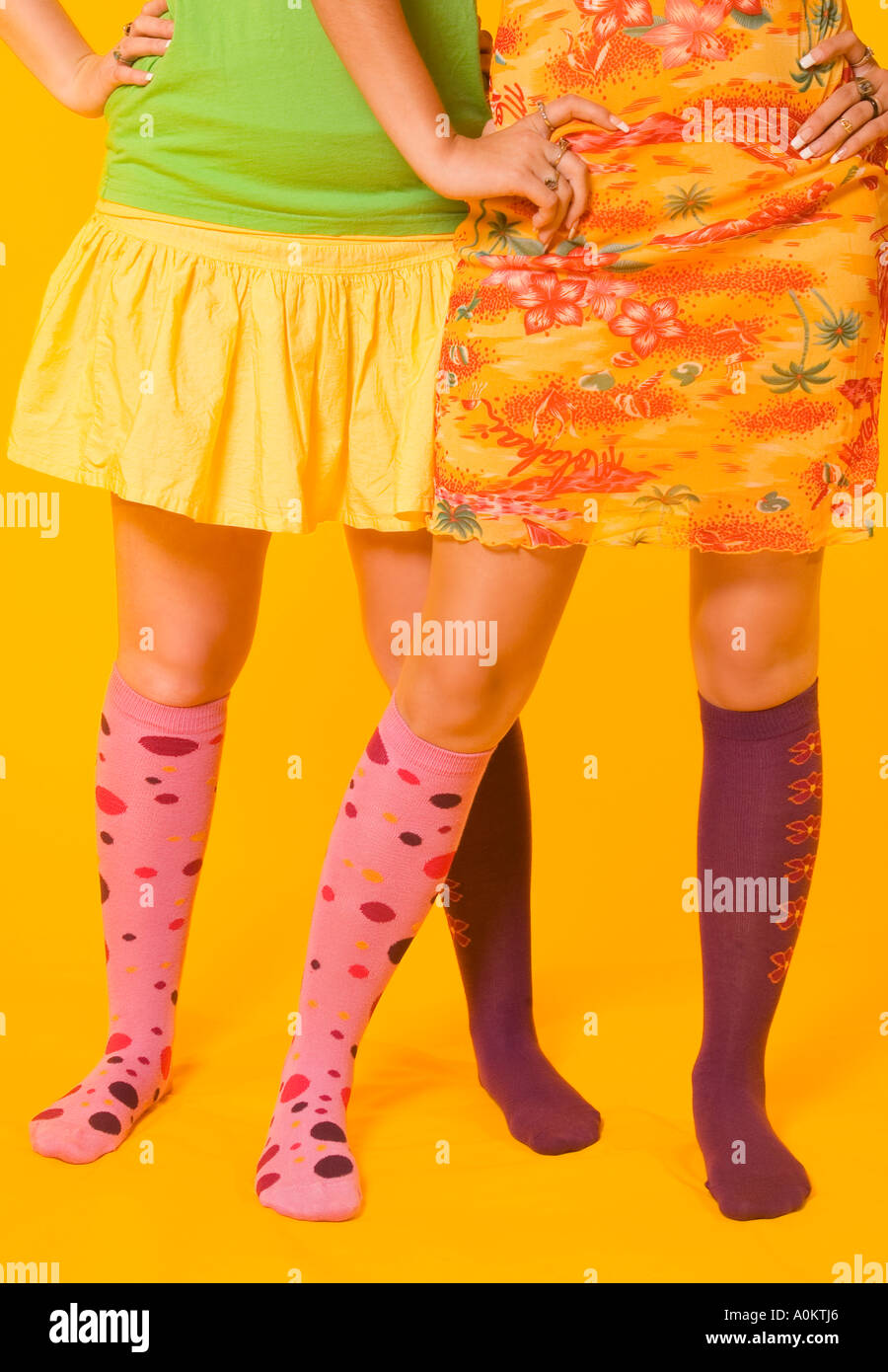 Torso and Legs Of Two Caucasian Teen Girls Wearing Colorful Mismatching ...