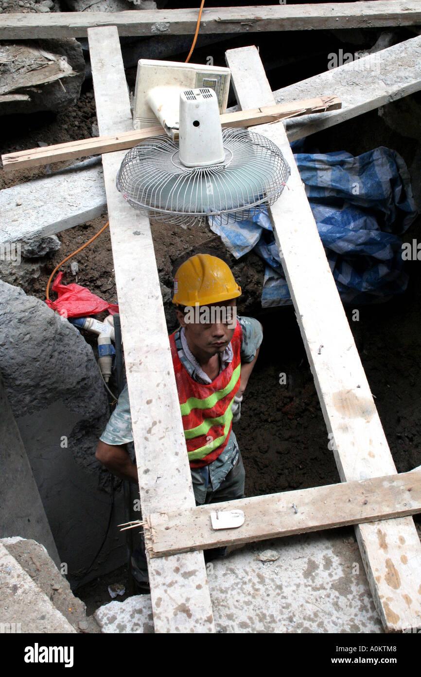 Construction worker works below the ground in Wanchai, Hong Kong Stock ...