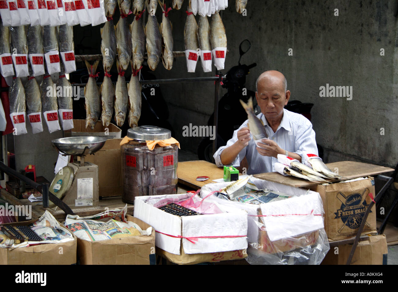 Old man packaging dried fish hi-res stock photography and images - Alamy