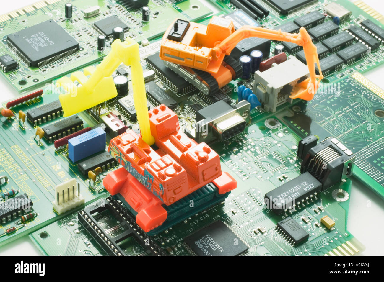 Miniature Earthmovers on Computer Circuit Boards Stock Photo - Alamy