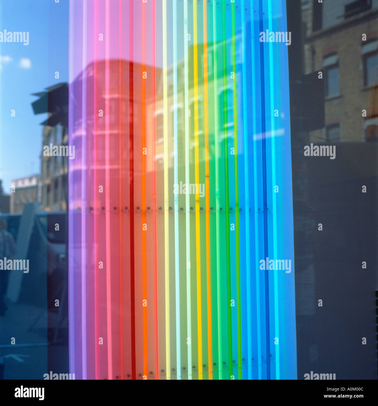 Rainbow light display and reflections of houses in a shop window in ...