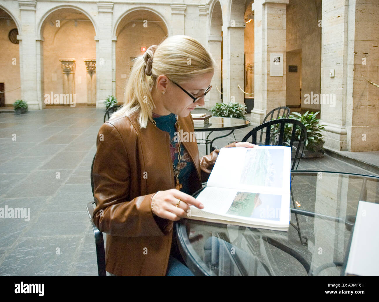 A young blonde lady studies at the Fogg Art Museum in Harvard Cambridge ...
