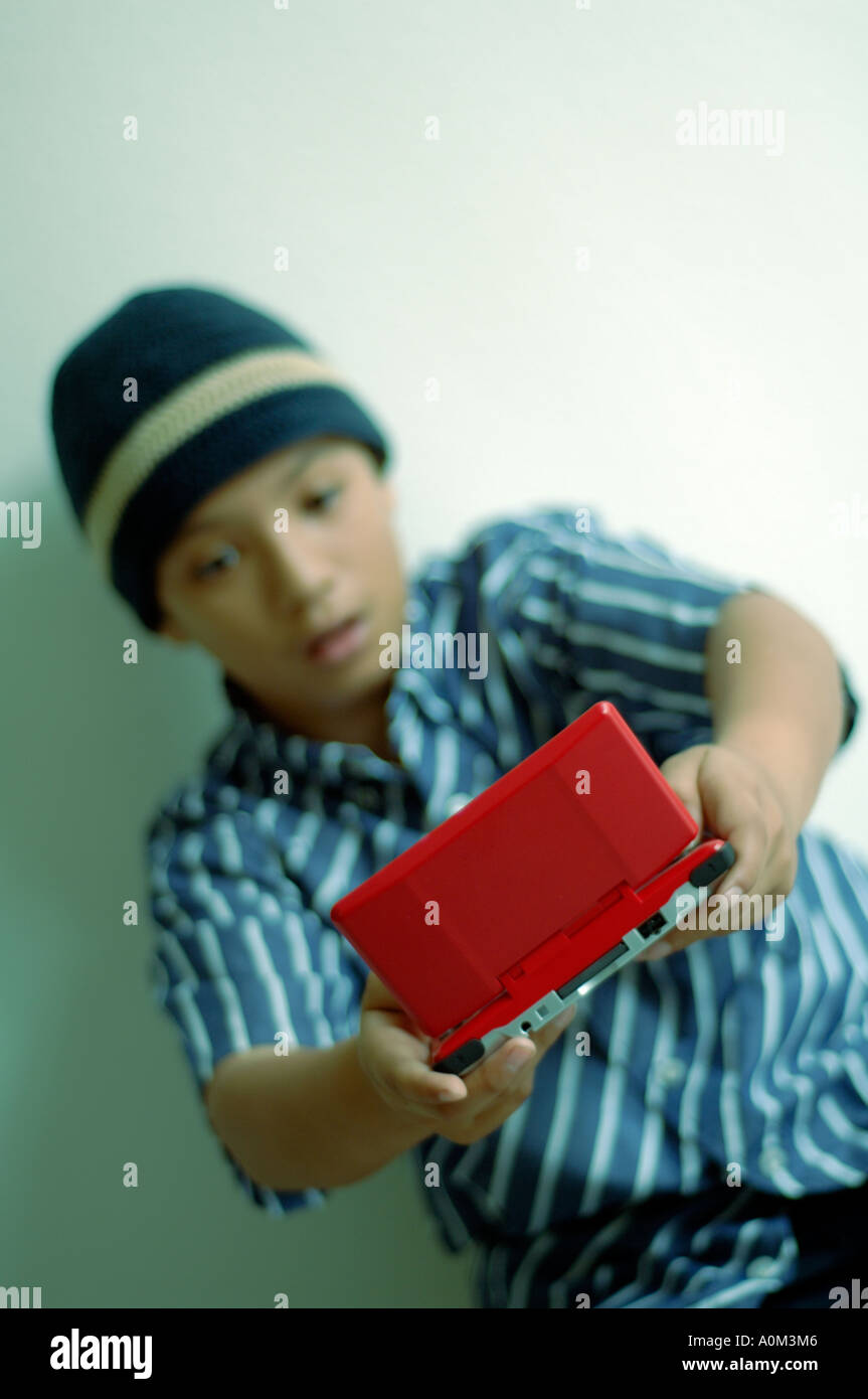 Portrait of 9 years old boy playing with a handheld video game Stock ...