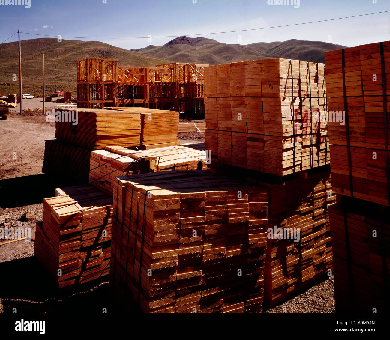 Stockpiles of lumber for use in framing up new buildings waiting for ...
