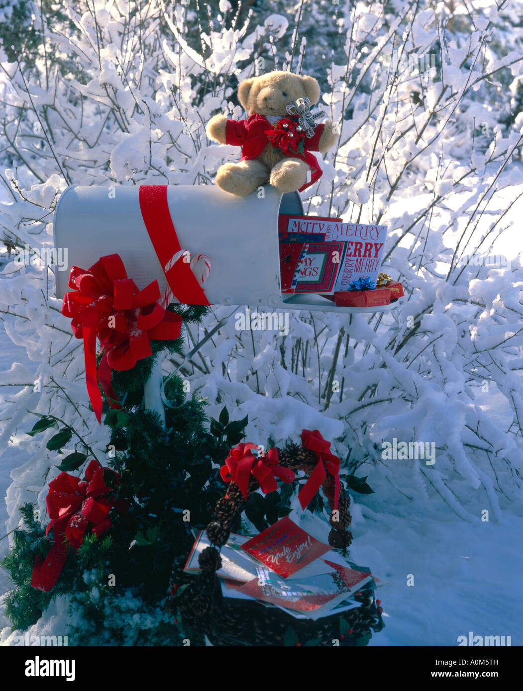 Mailbox stuffed with cards and presents with a jolly Teddy Bear on top ...