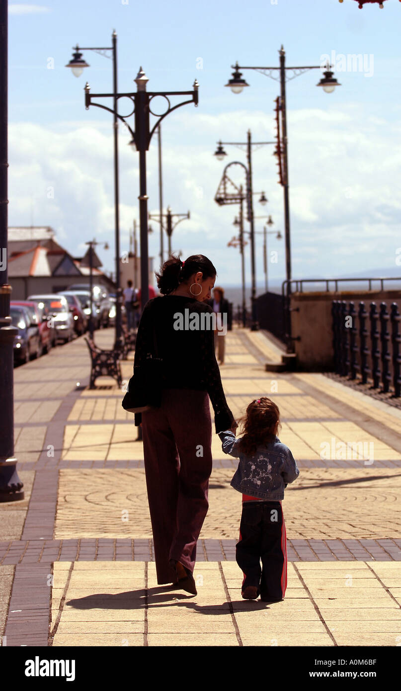 A mother and daughter walking the promenade on Porthcawls front Stock ...