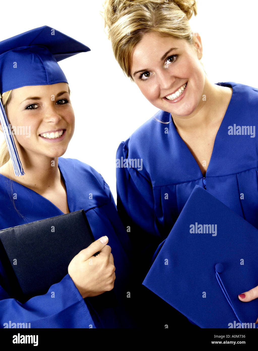 Girls in cap and gown for graduation Stock Photo - Alamy