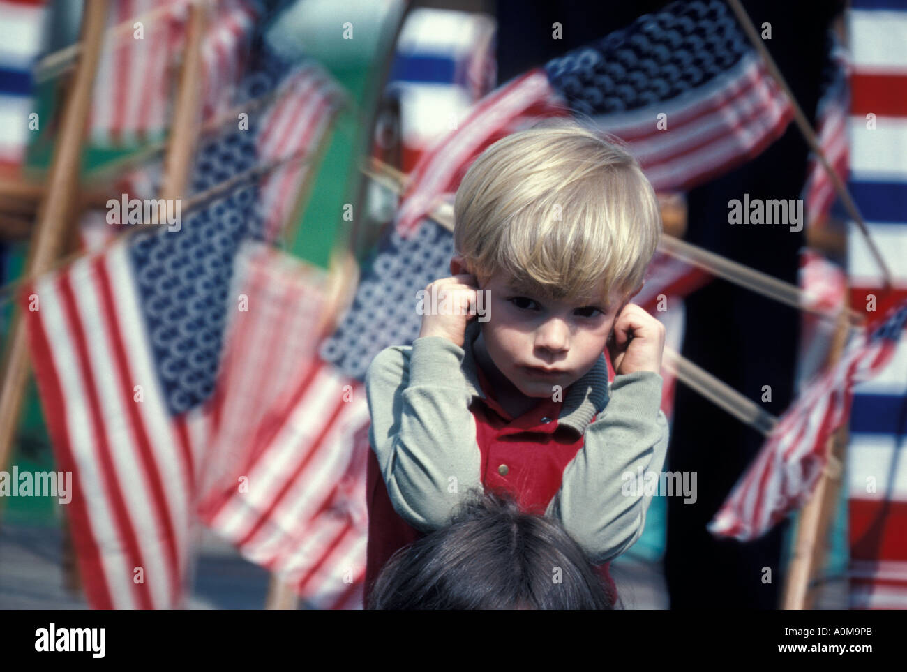 young boy cover ears american flag small town holiday parade PA ...