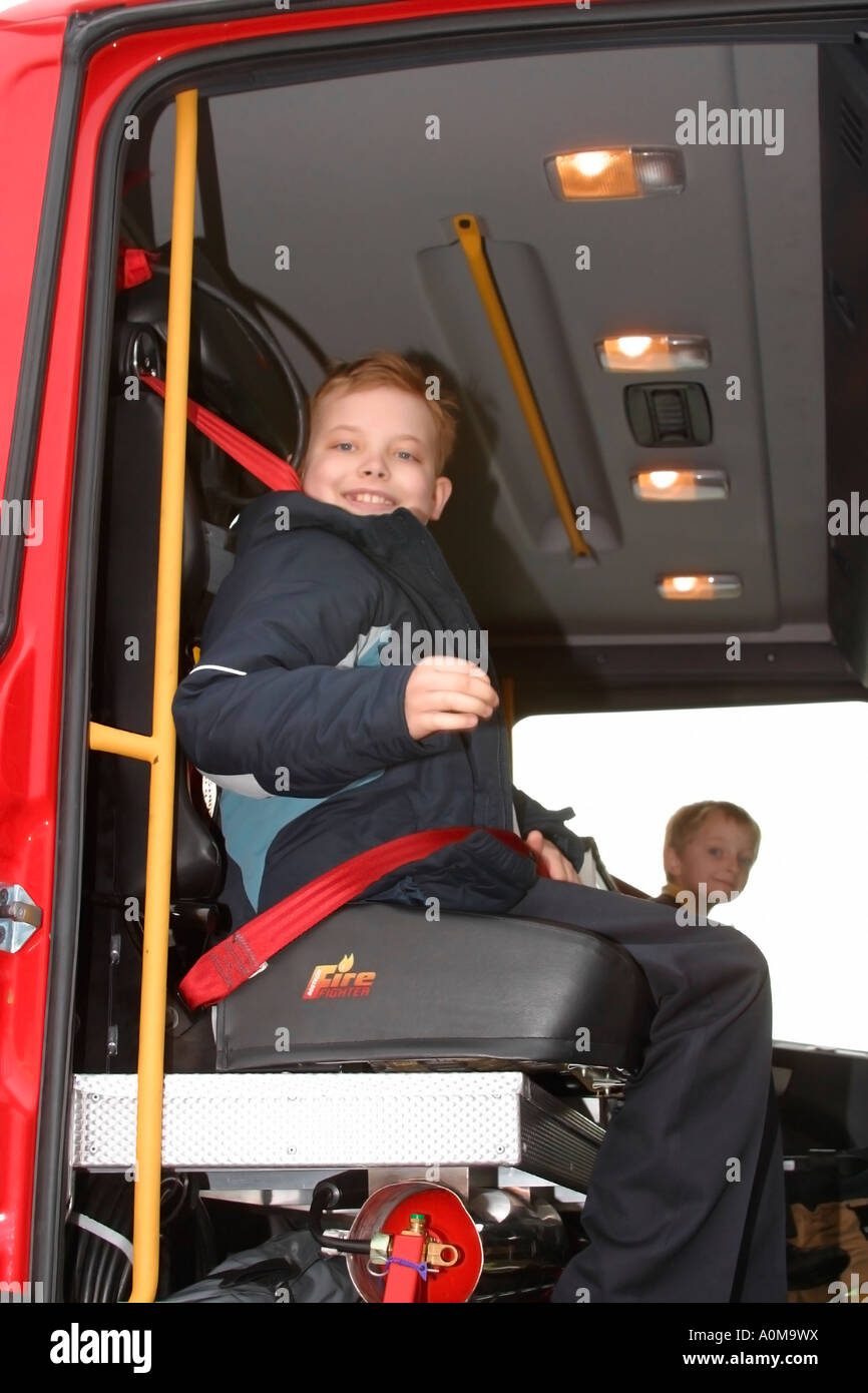 Young boys sitting in cab of English fire engine Stock Photo - Alamy