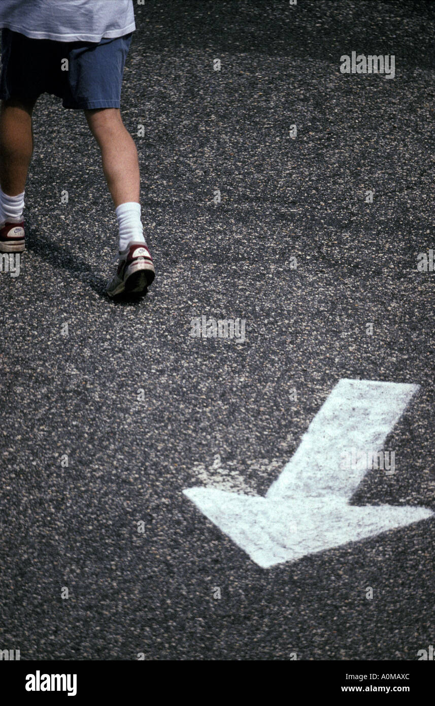 white arrow indicator walking person paved asphalt street copy space ...