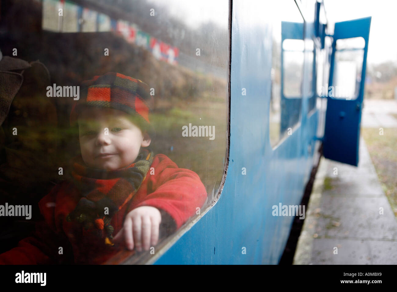 Toddler on train looking through window Stock Photo - Alamy