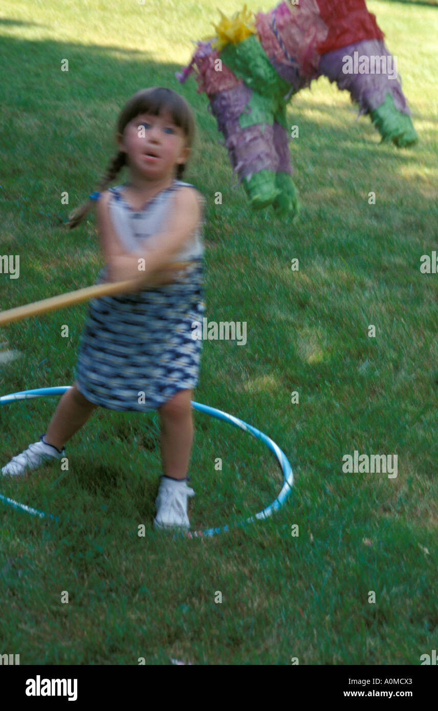 1 one young girl swings at party pinata Stock Photo - Alamy