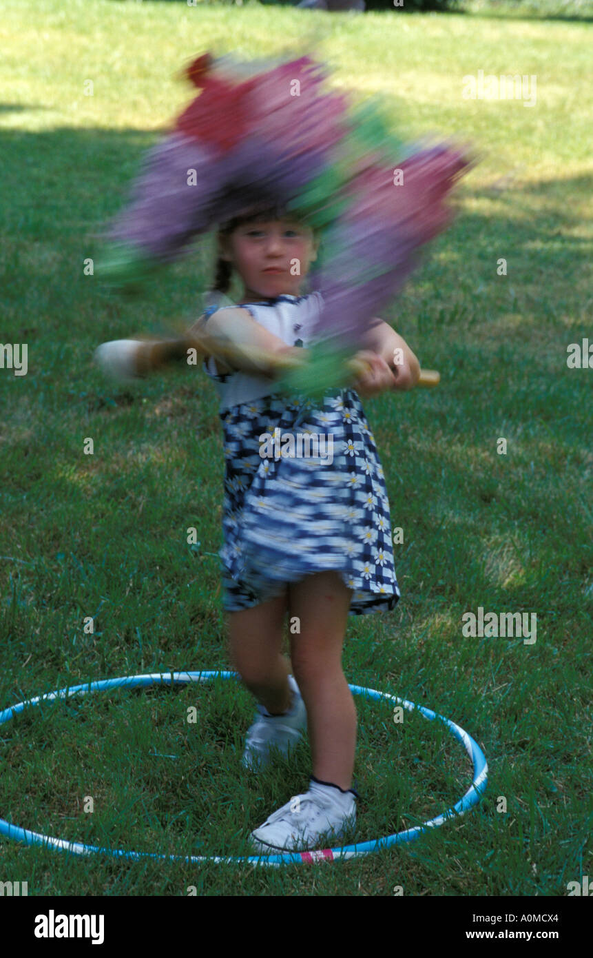 1 one young girl swings at party pinata Stock Photo - Alamy