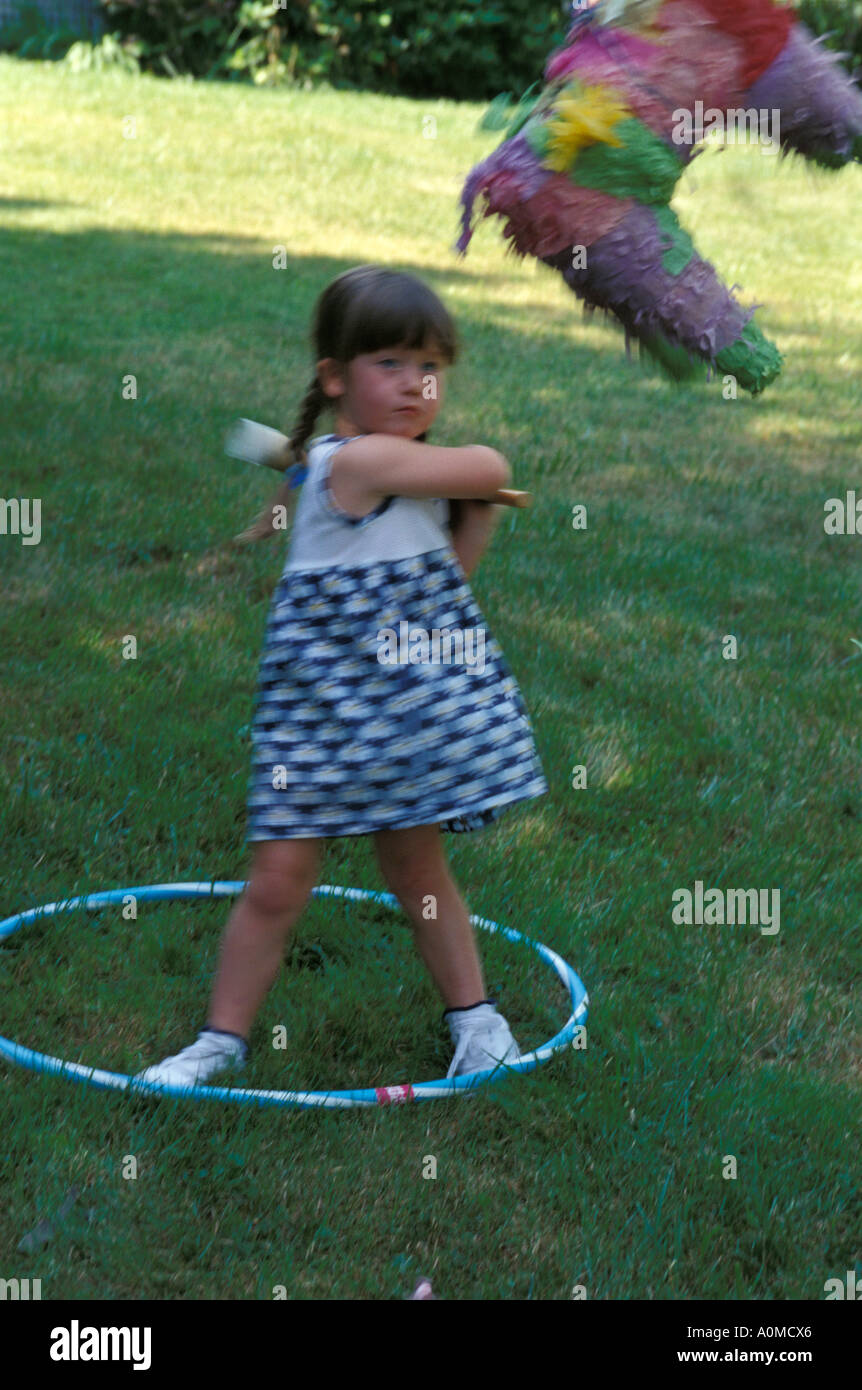 1 one young girl swings at party pinata Stock Photo - Alamy