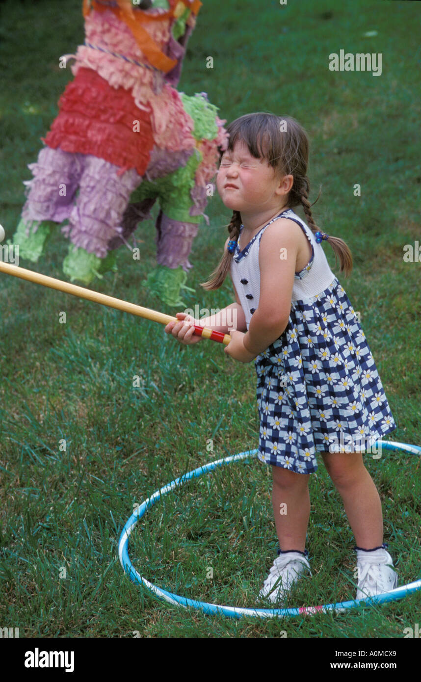 1 one young girl swings at party pinata Stock Photo - Alamy