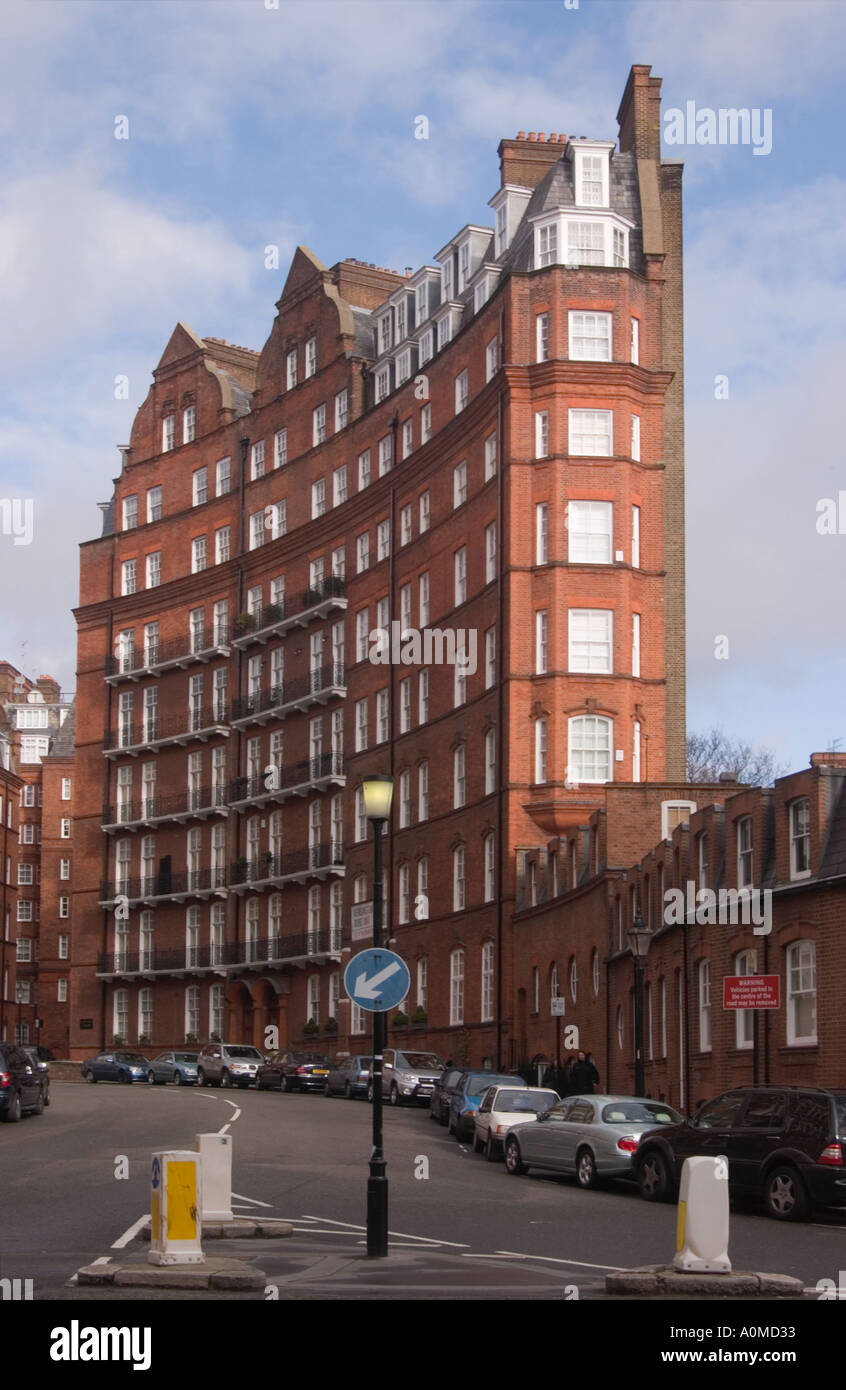 A tall thin curved apartment building in London England on a sunny day ...