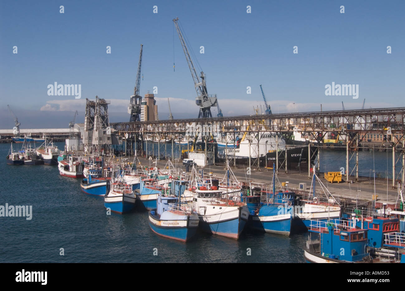 A row of blue ships with along a pier in Table Bay in Cape Town South ...